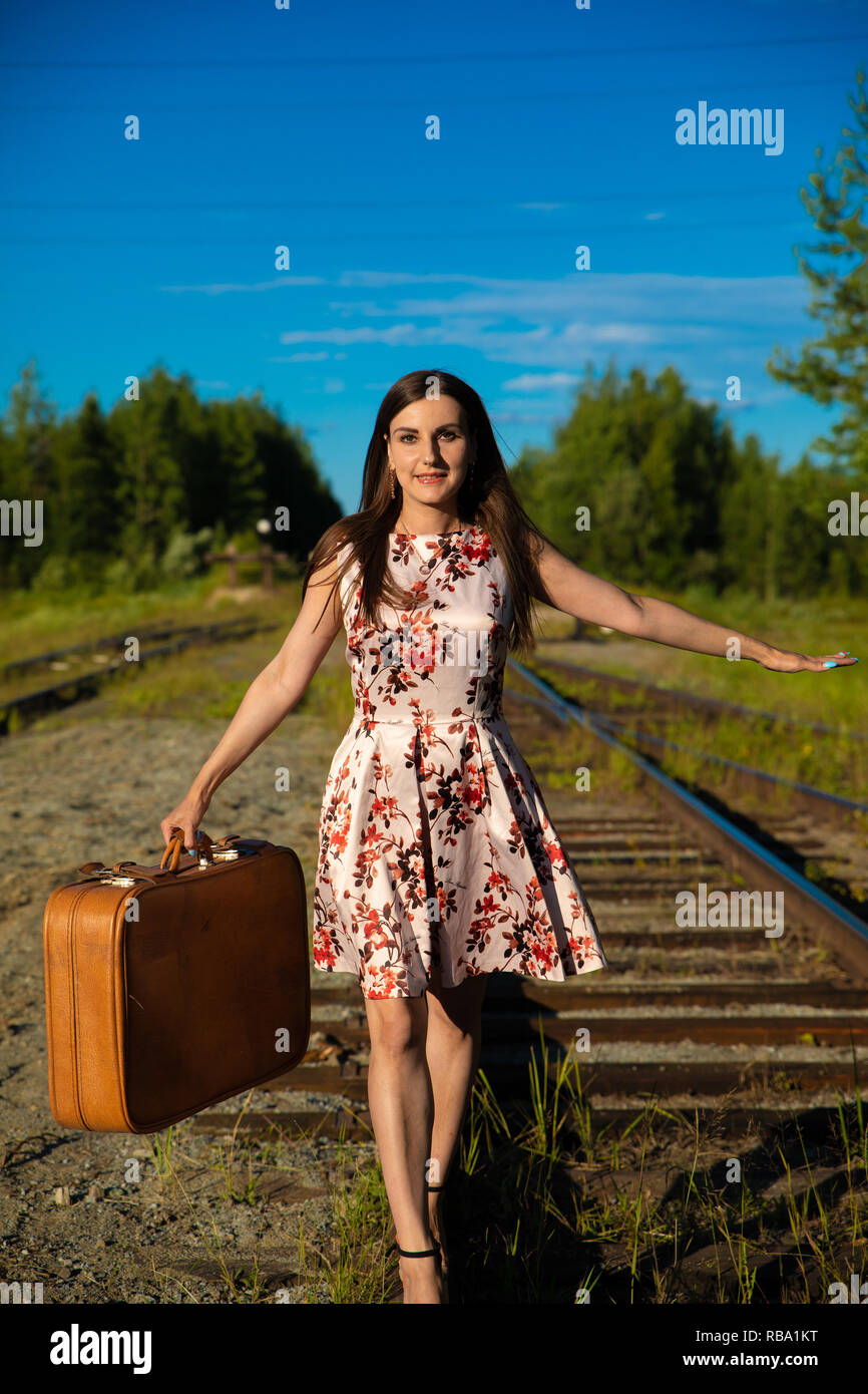 girl on the tracks waiting for the train and travel Stock Photo - Alamy