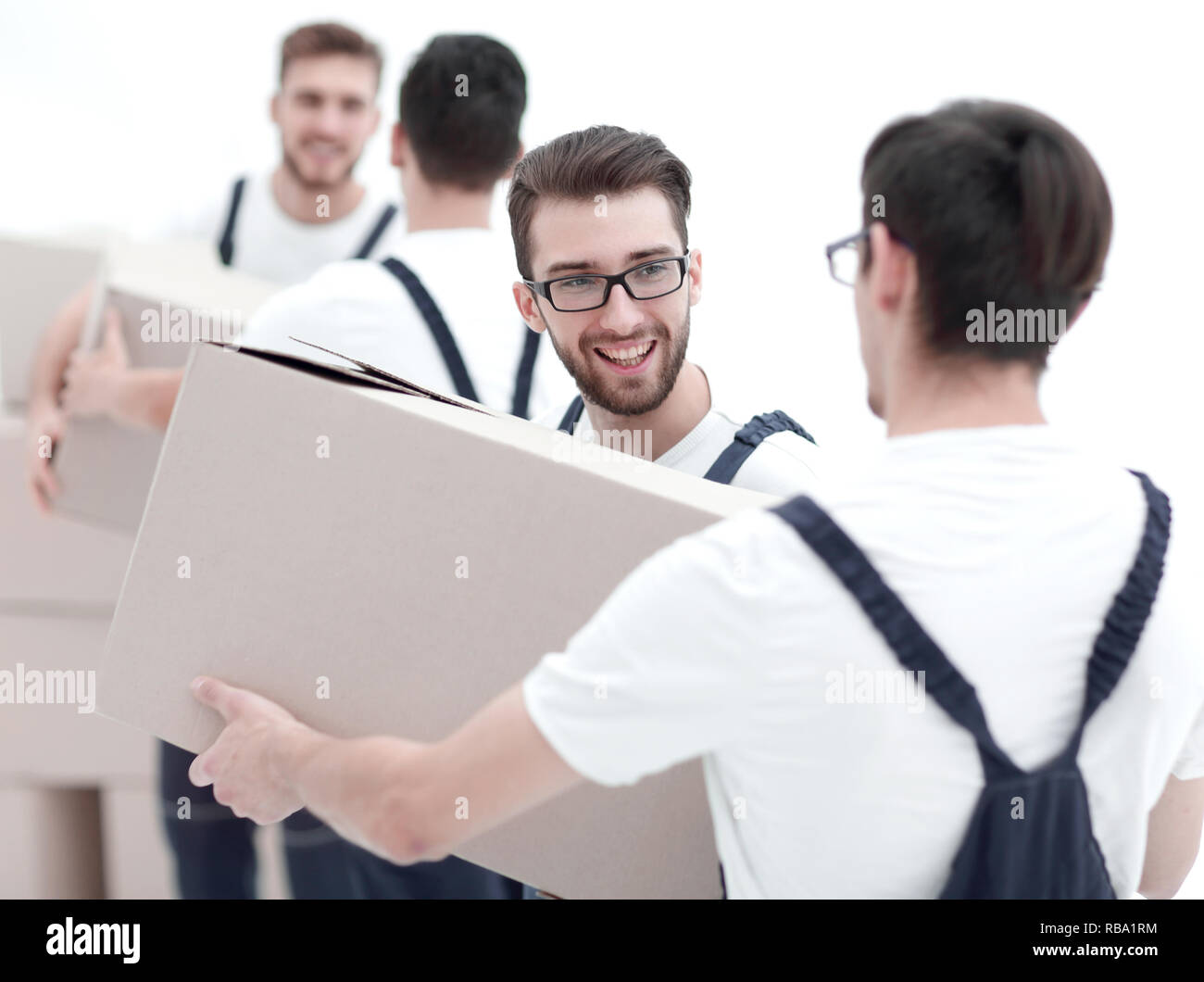 Photo workers pass each other boxes when moving flats Stock Photo - Alamy