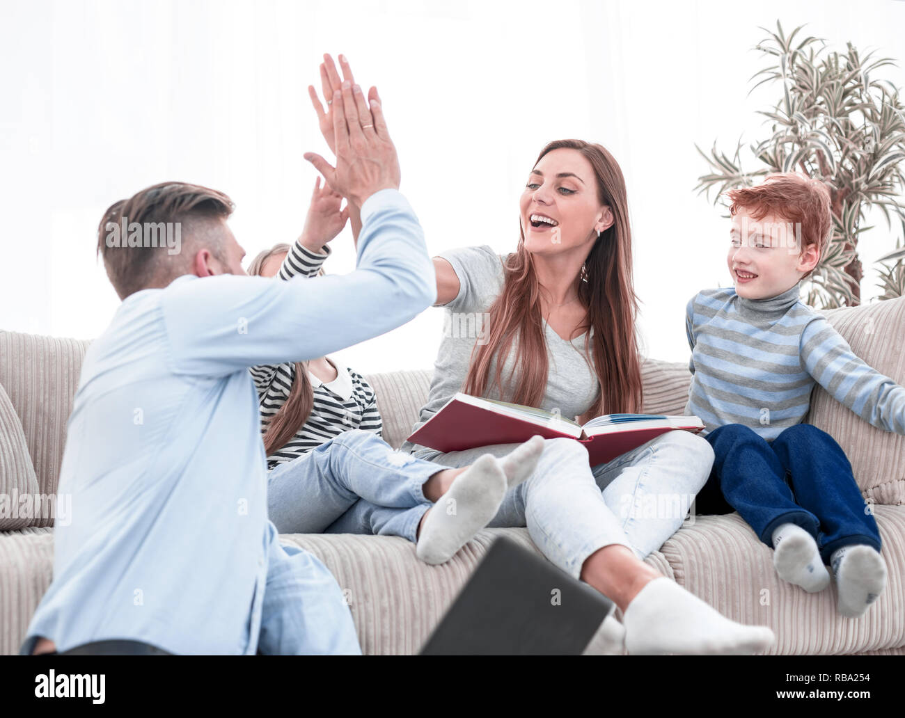 happy parents giving each other a high five Stock Photo - Alamy