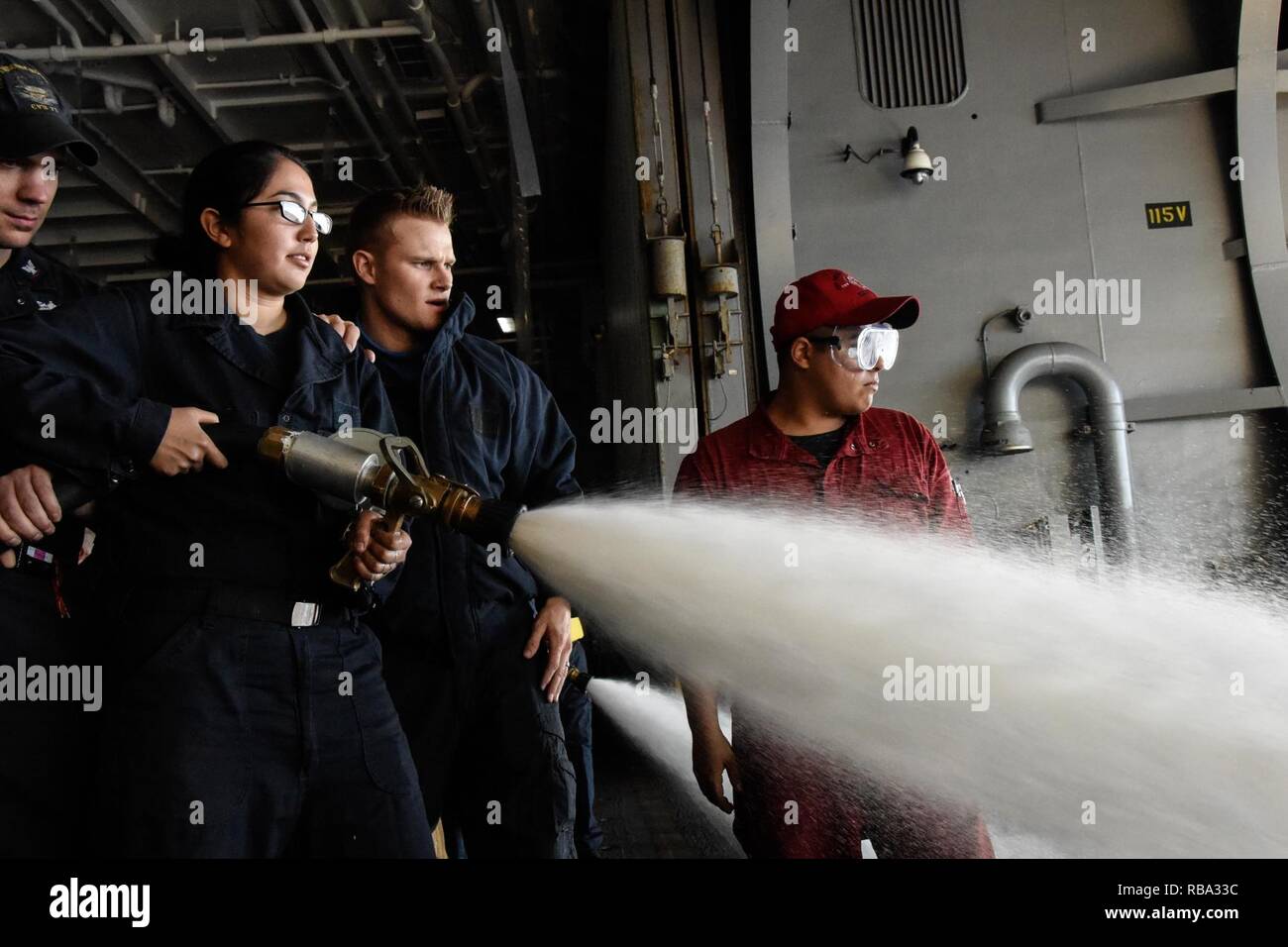 SAN DIEGO (Dec. 19, 2016) Sailors operate a fire hose while spraying ...