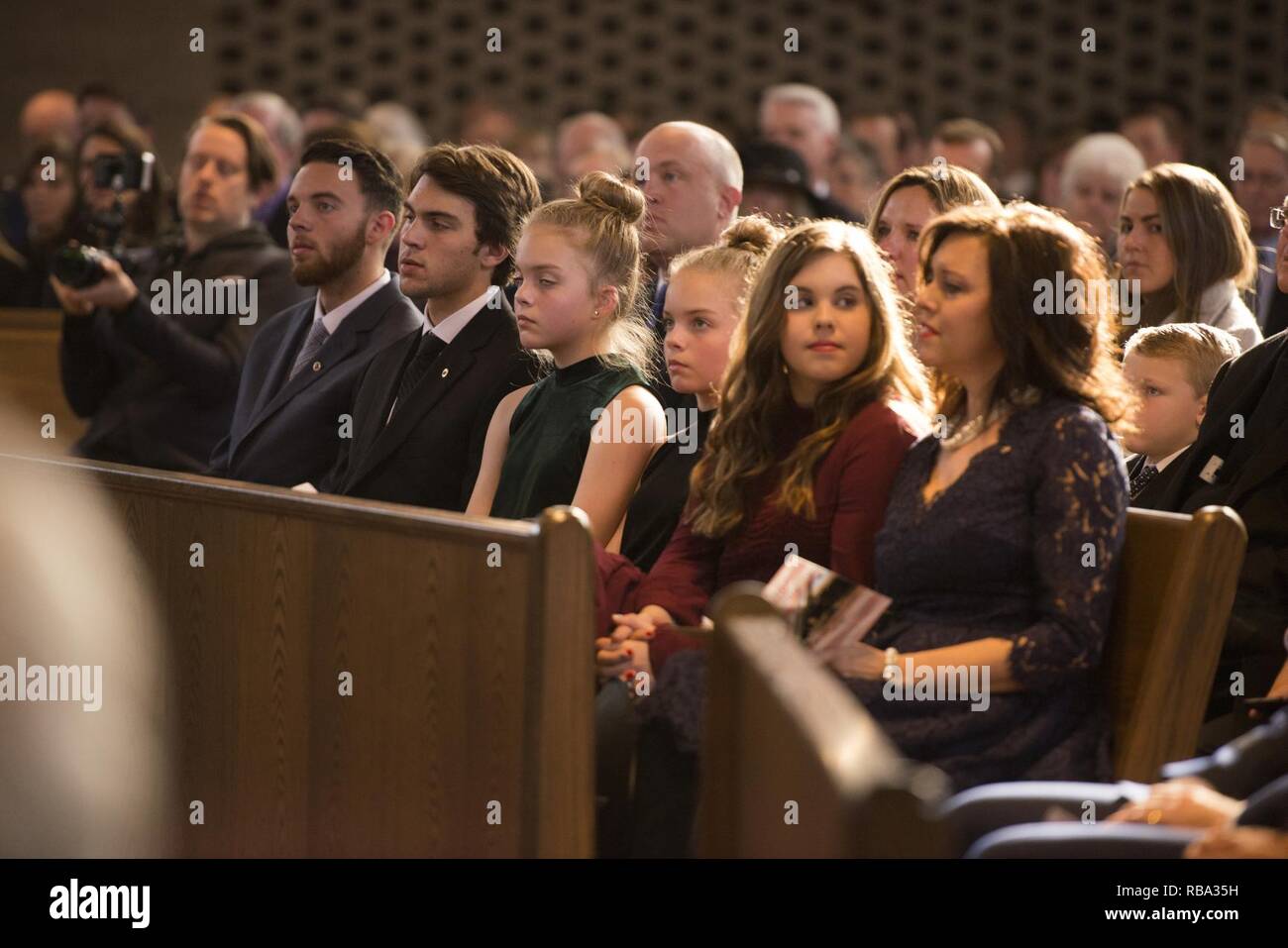 Ginger Gilbert Ravella, right, sits next to her five children during ...