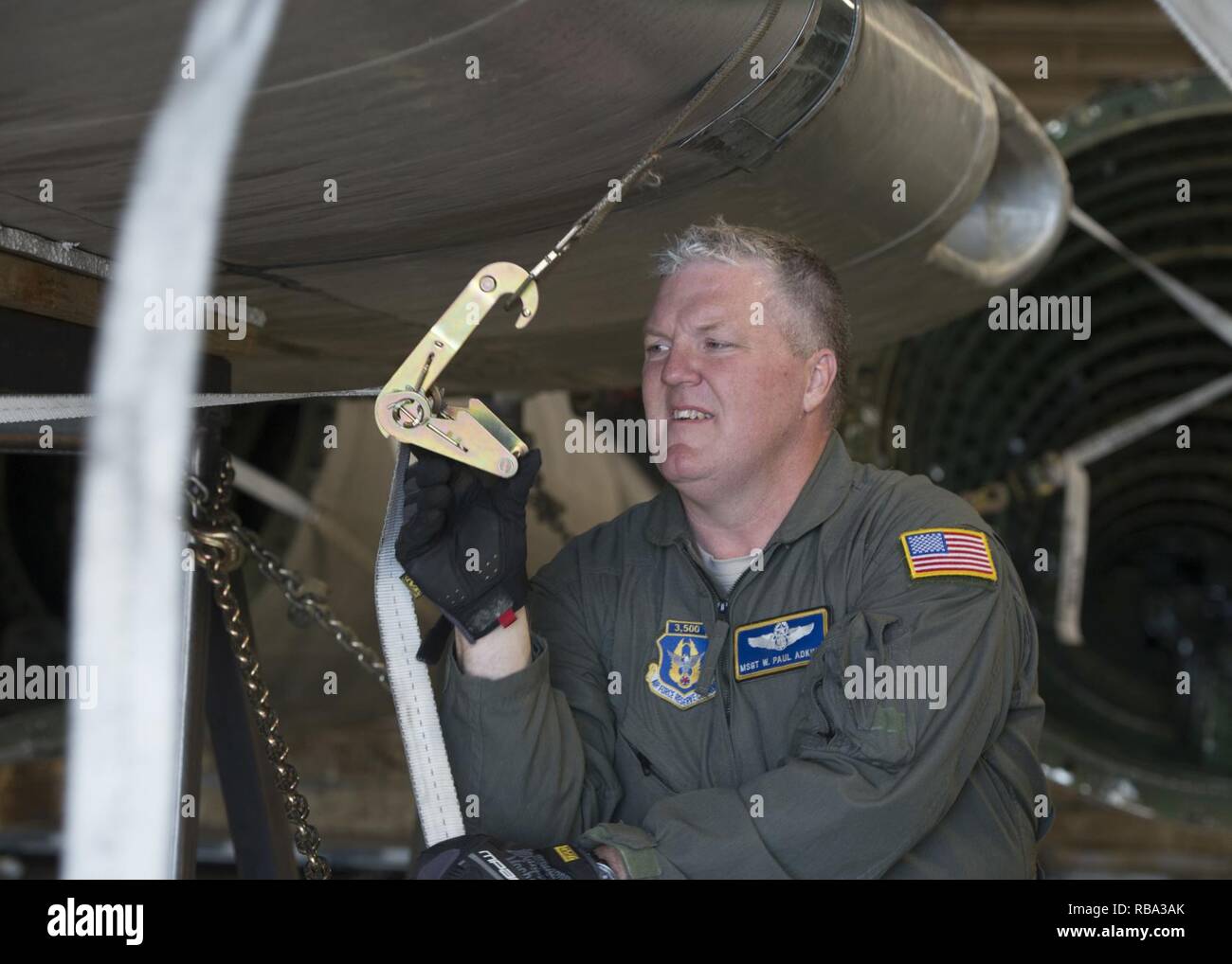 Master Sgt. Paul Adkins, 709th Airlift Squadron loadmaster, straps down ...