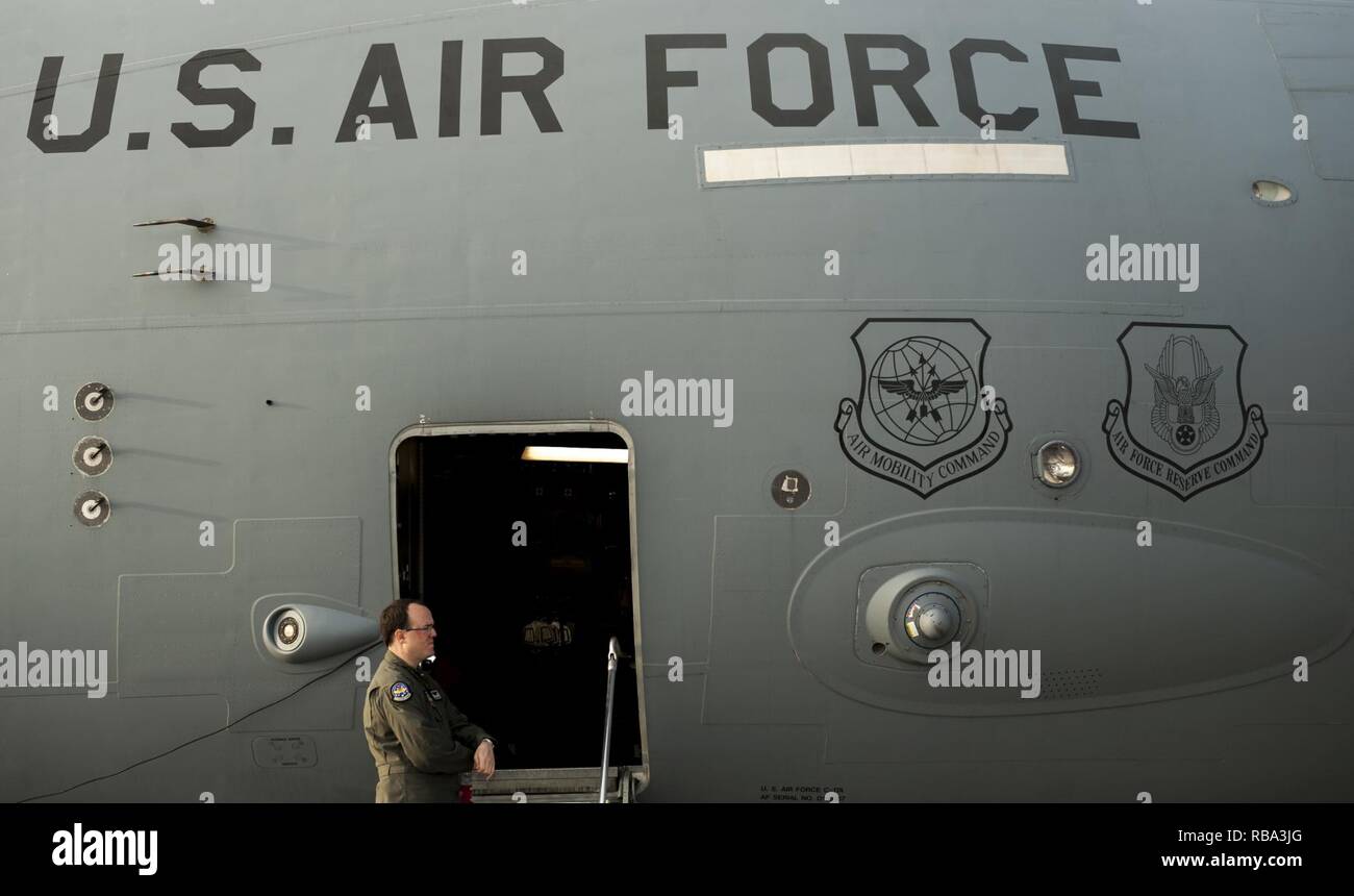 Tech. Sgt. Mike Smith, loadmaster, stands by a C-17 Globemaster III ...