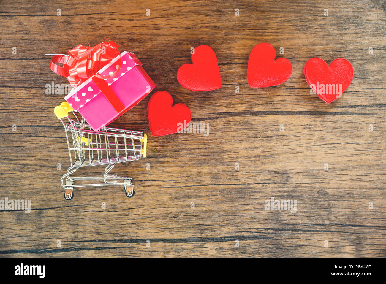 Valentines day shopping and red heart gift box on shopping cart love ...