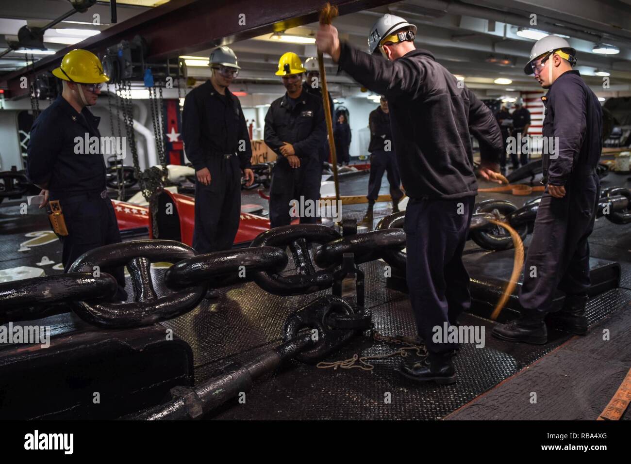 PACIFIC OCEAN (Dec. 21, 2016) Sailors remove the riding stopper during ...