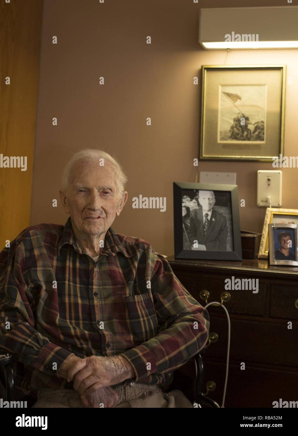 Retired 1st Lt. John J. O’Leary sits in front of his signed photo of ...