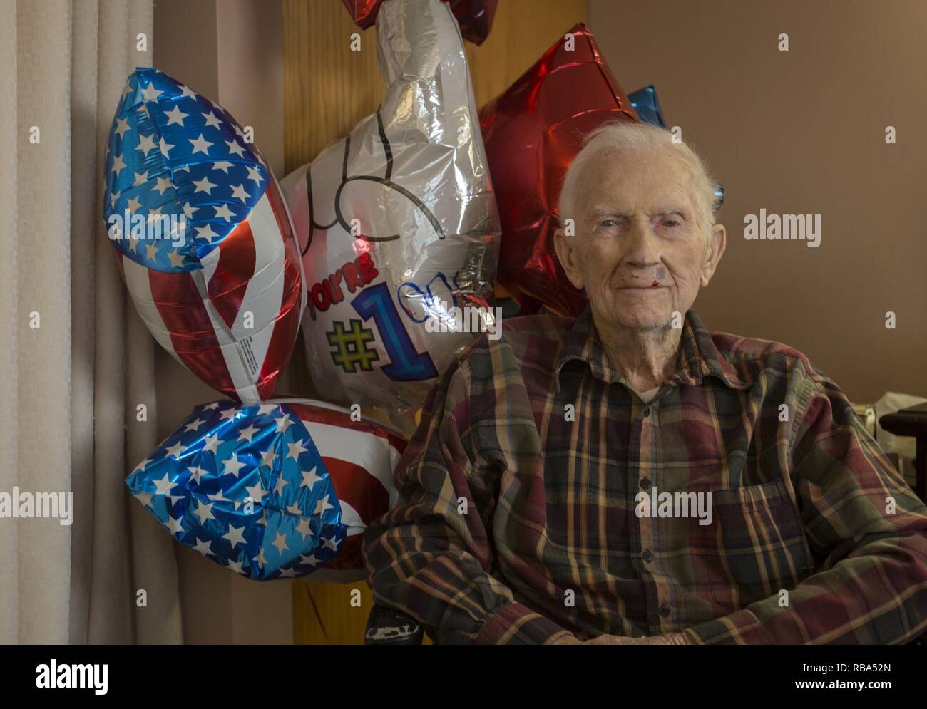 Retired 1st Lt. John J. O’Leary sits in front of birthday balloons at ...