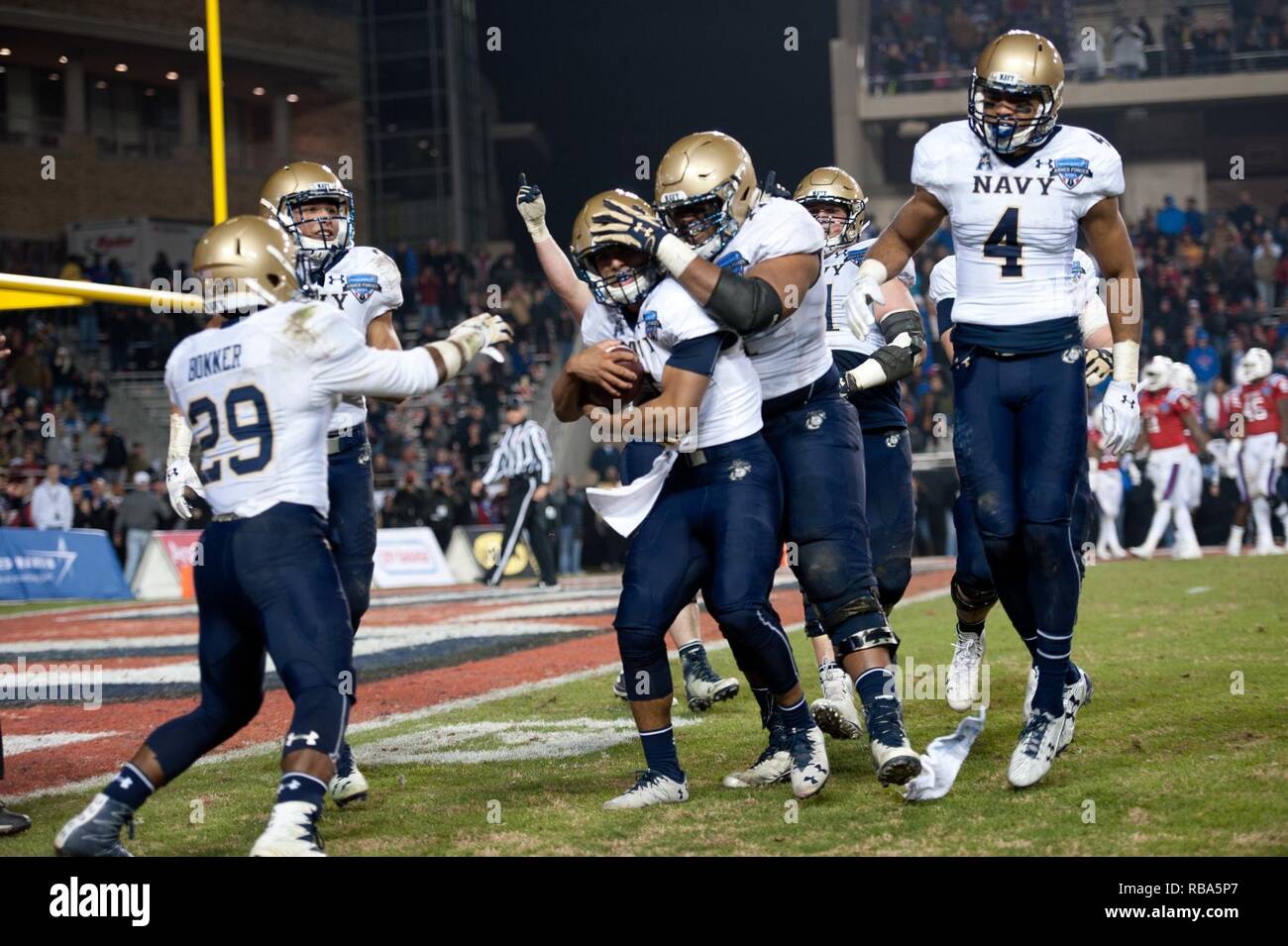 Navy quaterback Malcolm Perry celebrates with his teamates after ...