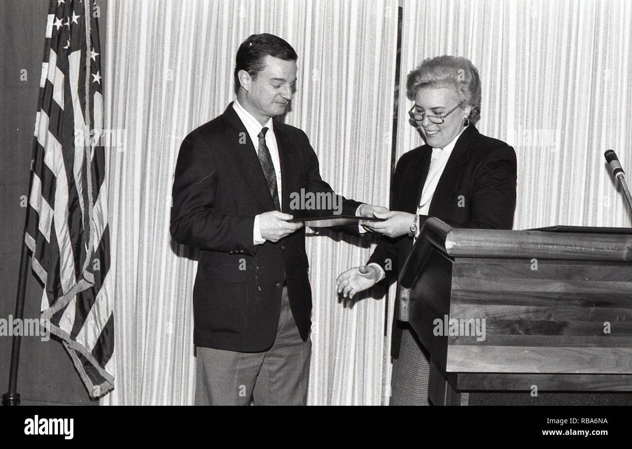MAN ACCEPTING AWARD AND SHAKING HANDS WITH WOMAN Stock Photo - Alamy