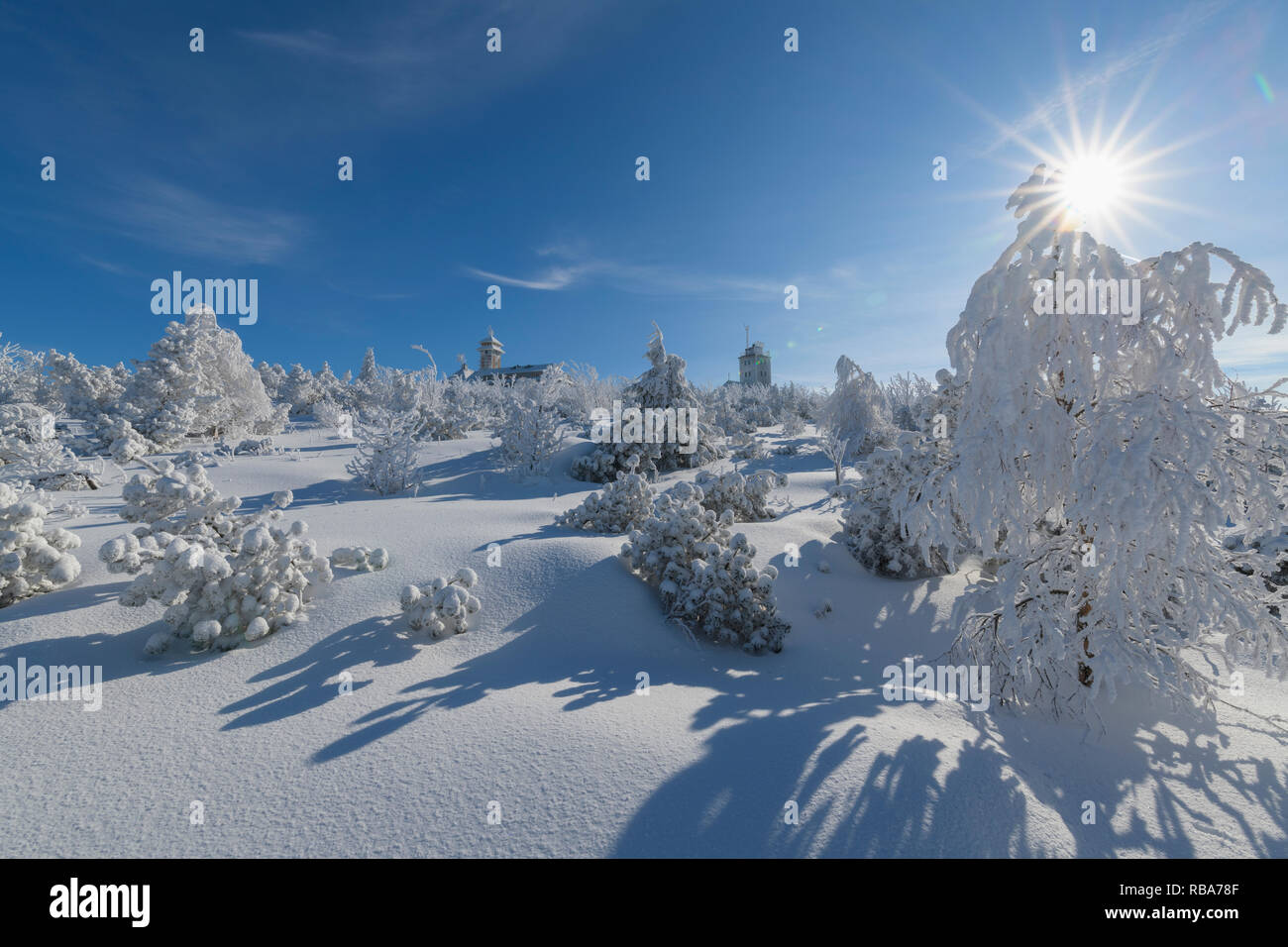 Snow covered winter landscape with sun Fichtelberghaus and weather ...