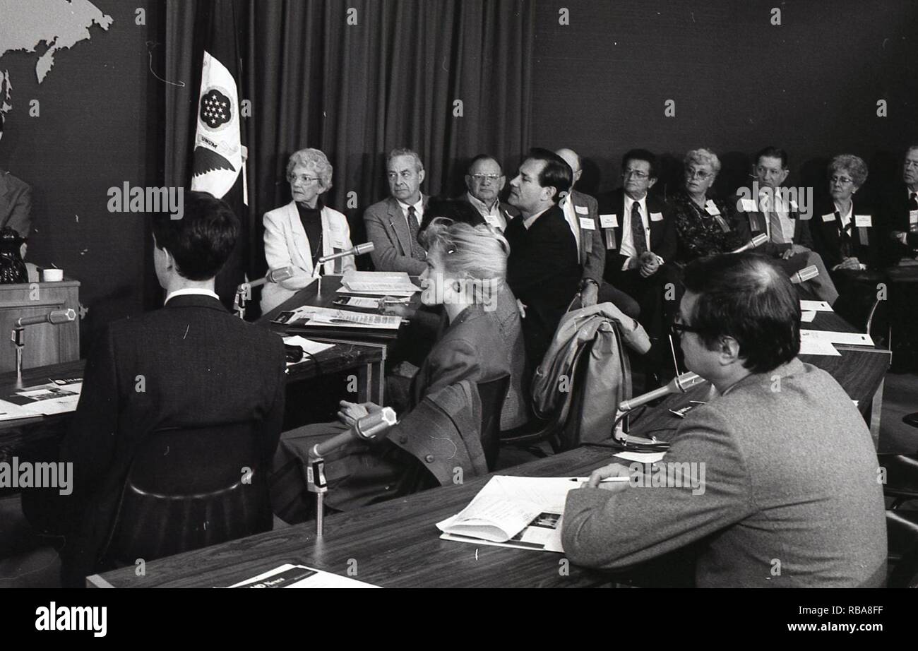 PEOPLE SITTING LISTENING TO MAN SPEAKING Stock Photo - Alamy