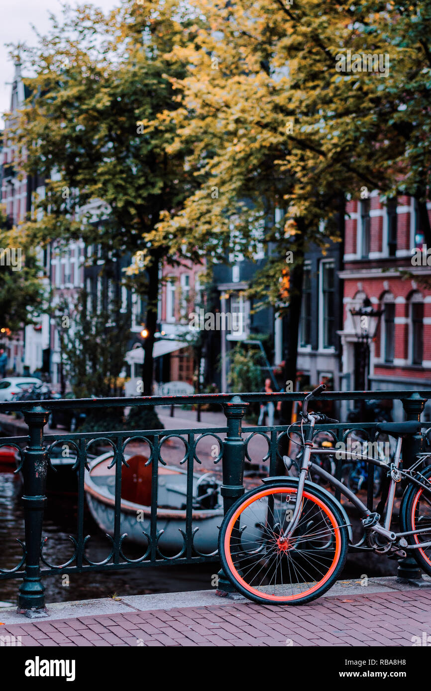 Bike parked on a bridge in Amsterdam, Netherlands. Typical cityscape ...