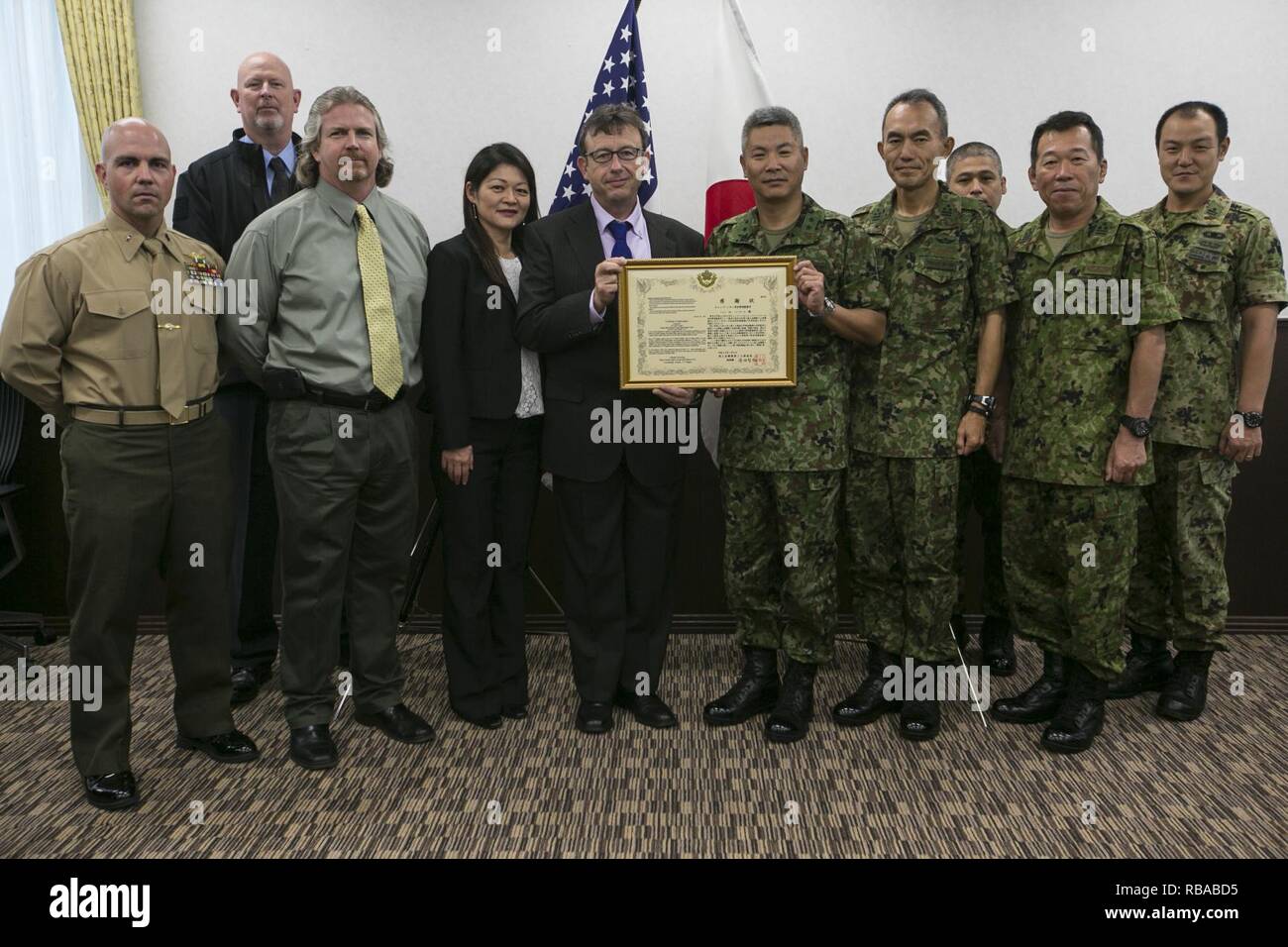 Maj. Gen. Tomofusa Harada, right center, and Mr. John Peters, left ...