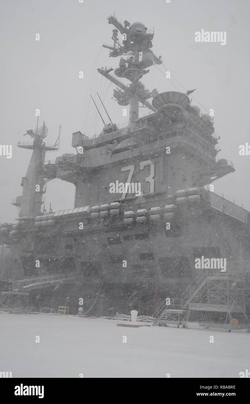 Snow from Winter Storm Helena covers the aircraft carrier USS George ...