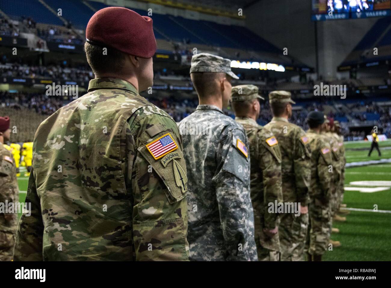 Soldiers stand at attention during the playing of the National Anthem ...