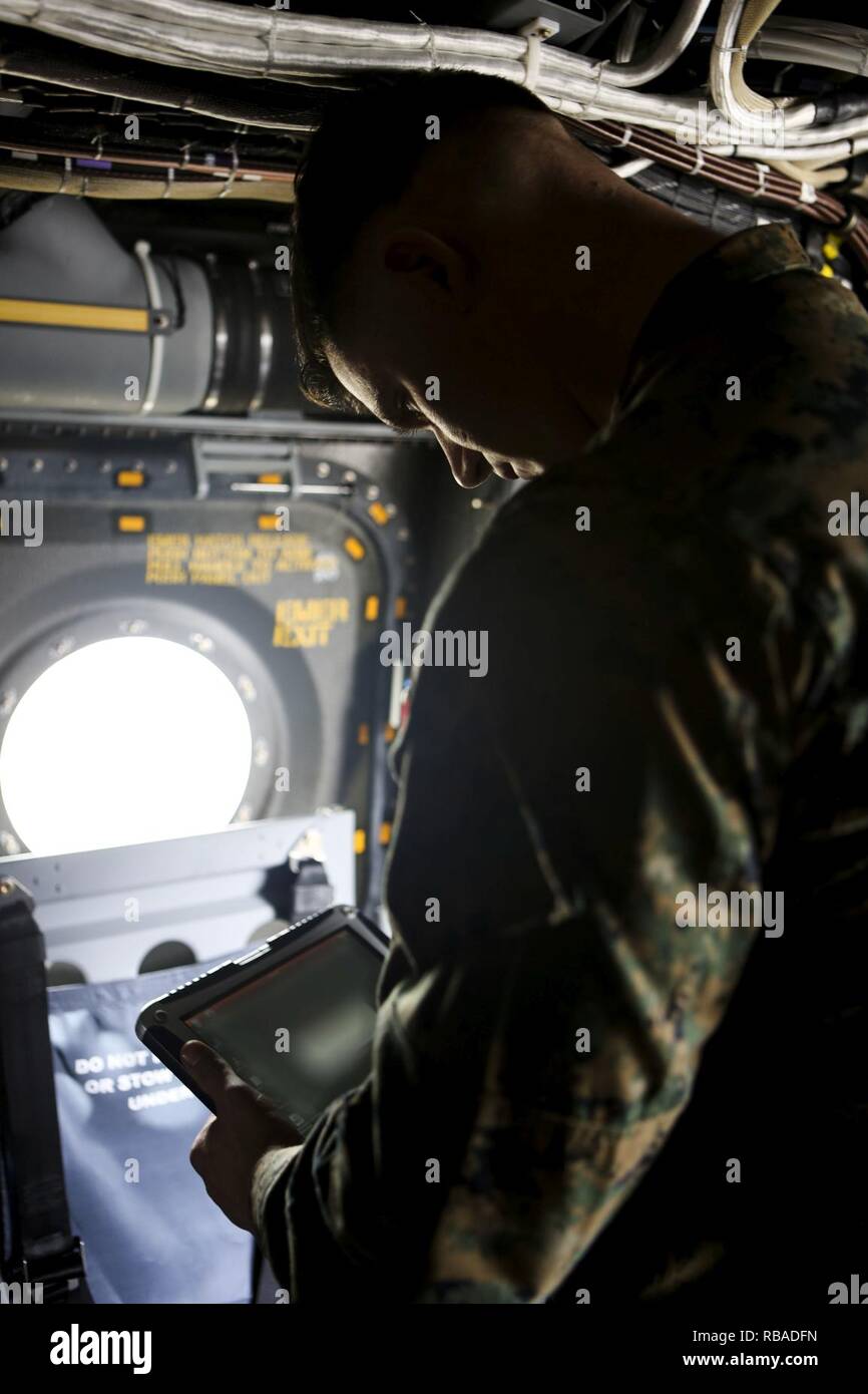 A Marine with 3rd Marine Aircraft Wing sets up the Hatch Mounted SATCOM ...