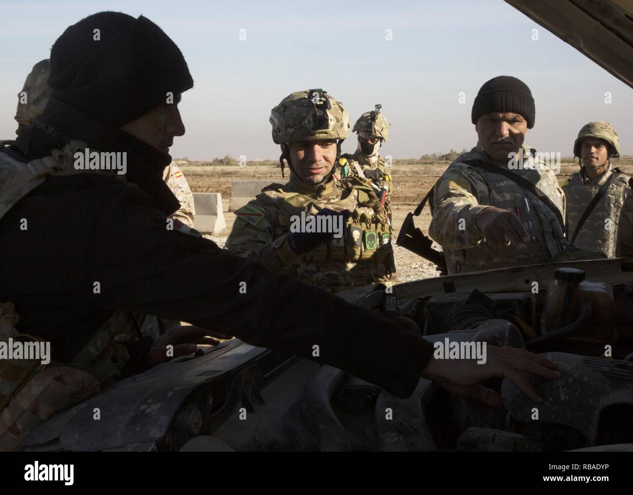 Iraqi soldiers inspect a vehicle during a checkpoint training exercise ...