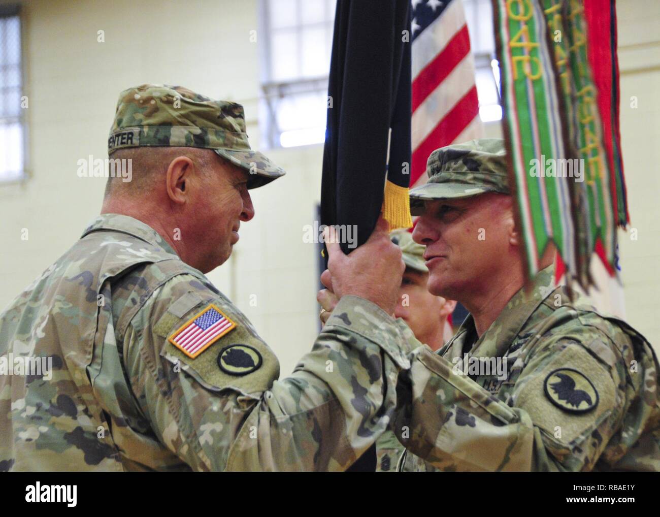 Maj. Gen. Troy D. Kok, outgoing commander, passes the colors to Maj ...