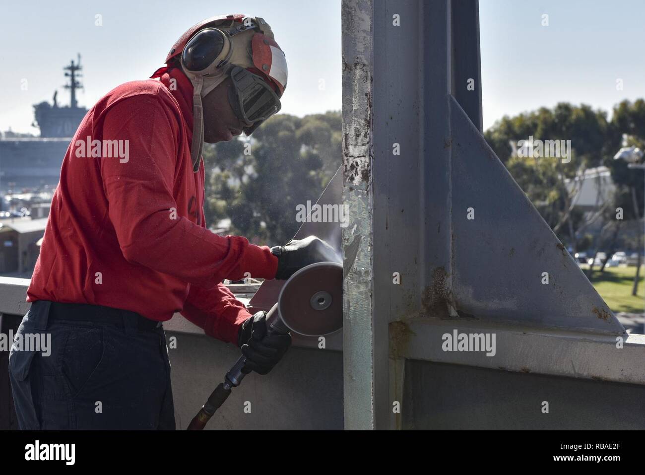 SAN DIEGO (Dec. 16, 2018) Airman Trey Dickerson sands an angle iron on ...