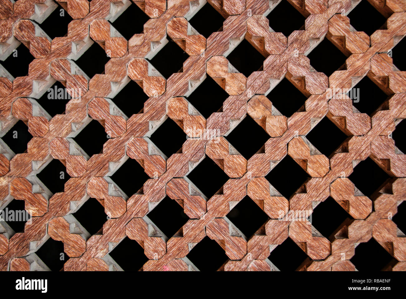 Texture of a wooden wall with carvings in the form of geometric figures ...