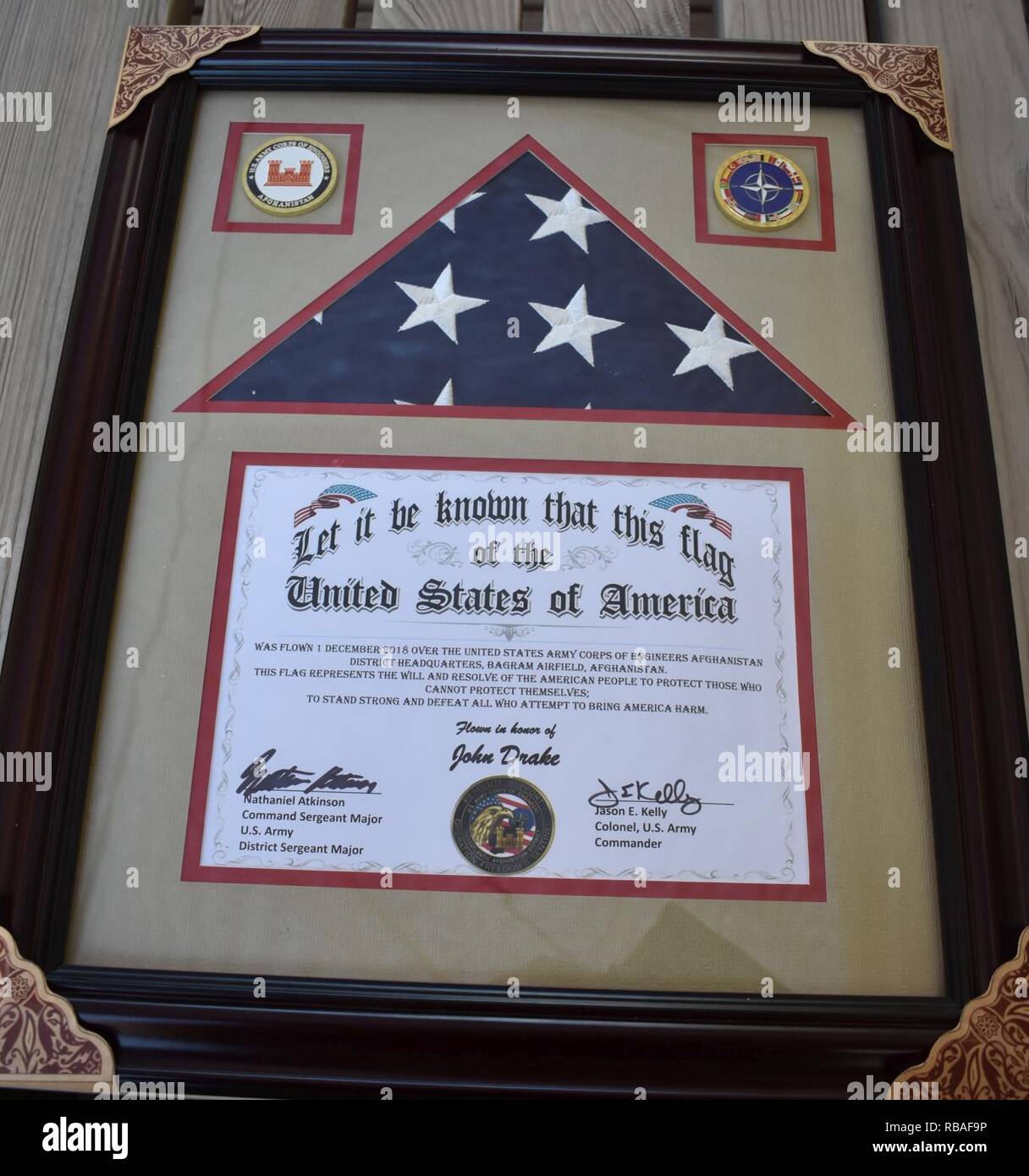 John E. Drake received a framed photo and the American Flag that was ...