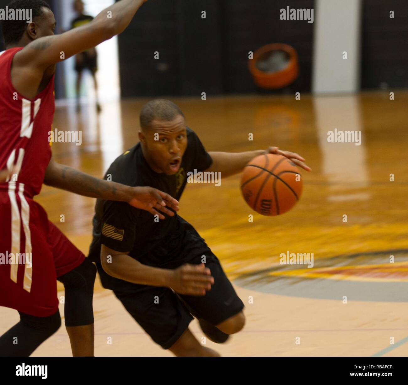 A soldier driving to the hoop, while playing basketball during Tropic ...