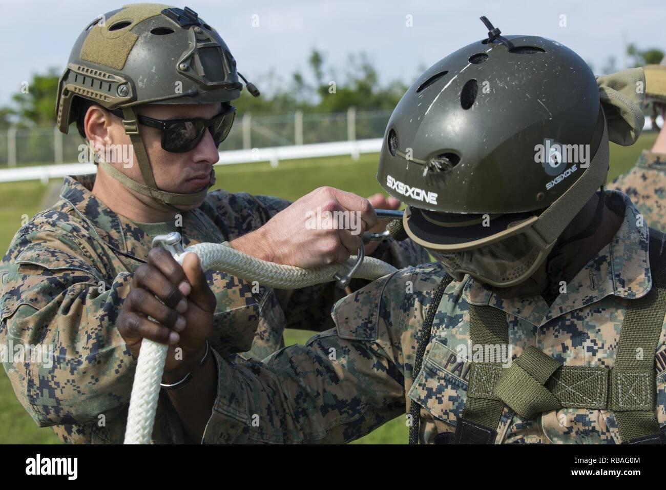 U.S. Marine Sgt. Matthew Jensen, left, secures U.S. Marine Sgt. Anthony ...