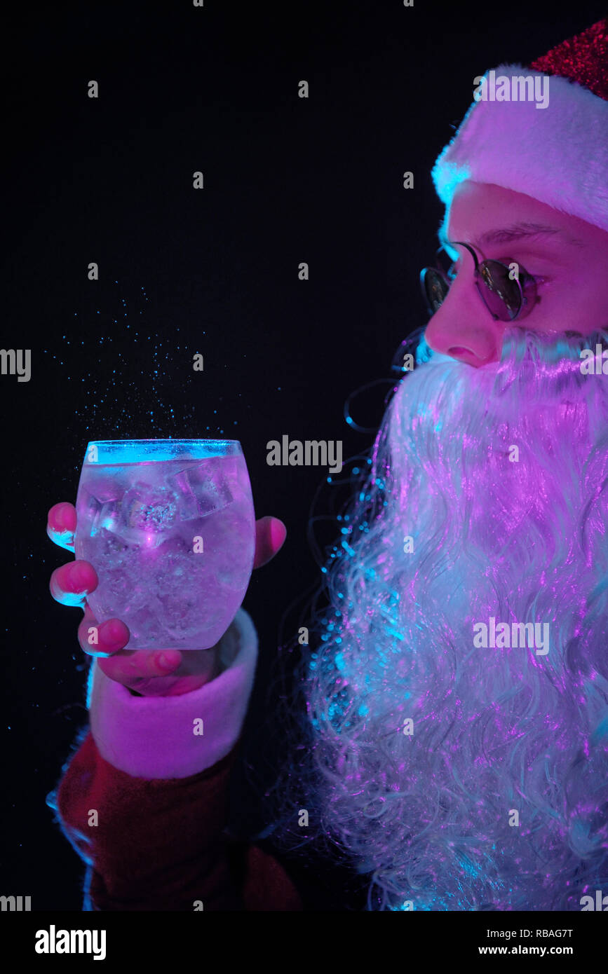 Young Santa Claus drinking carbonated tonic water Stock Photo - Alamy