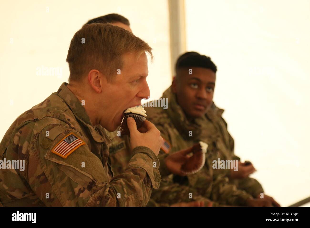 U.S. Soldiers eat cup-cakes during the grand opening of the Camp Aachen ...
