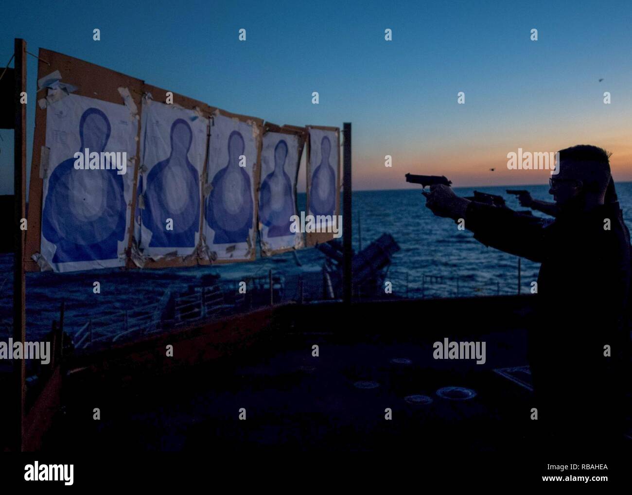U.S. Navy Sailors fire M9 pistols during a small-arms qualification ...