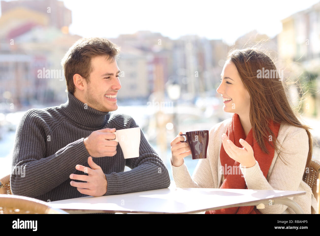 Happy couple talking on vacation drinking coffee in a restaurant Stock ...