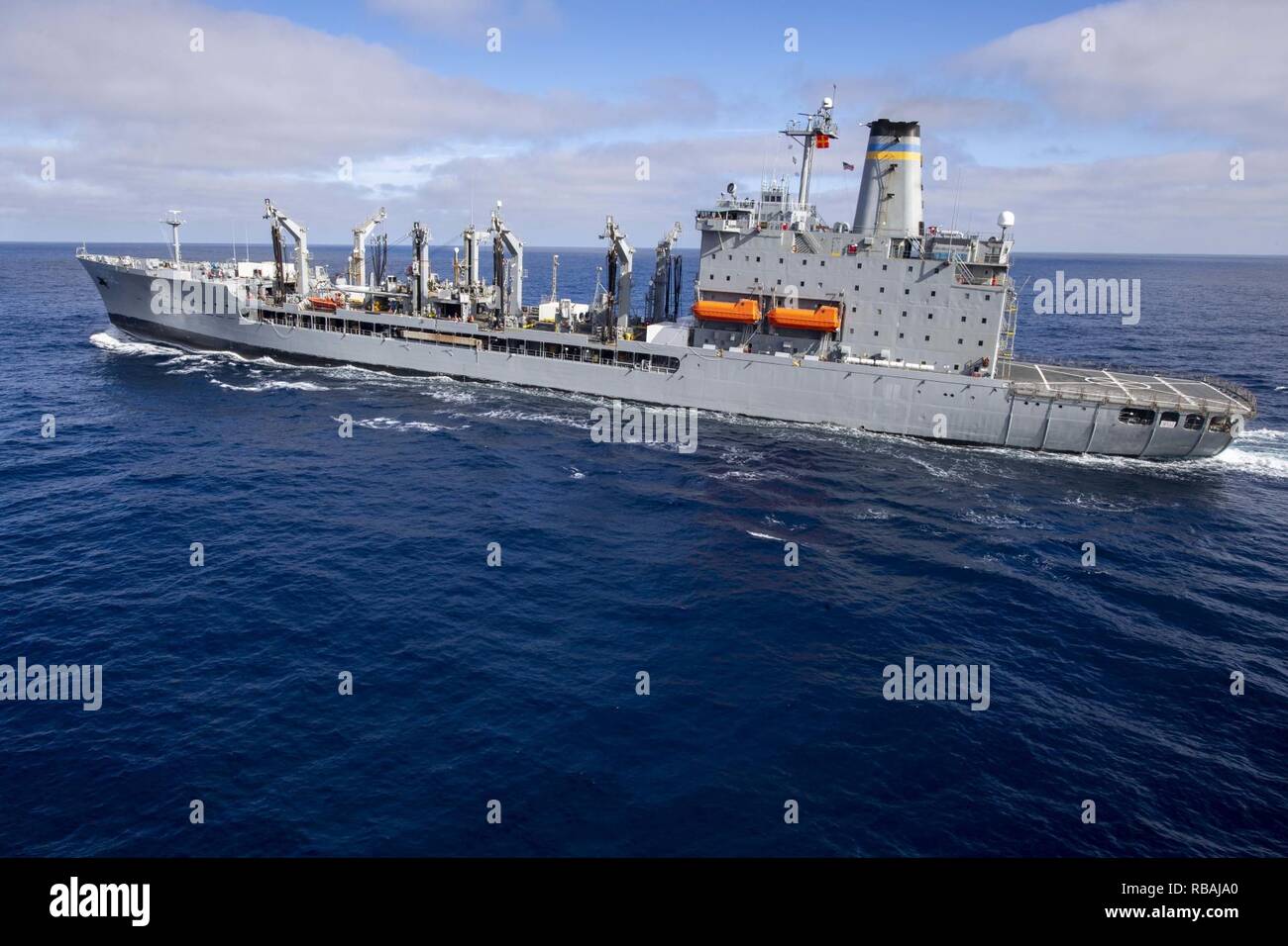 The fleet replenishment oiler USNS Yukon (T-AO 202) steams alongside ...