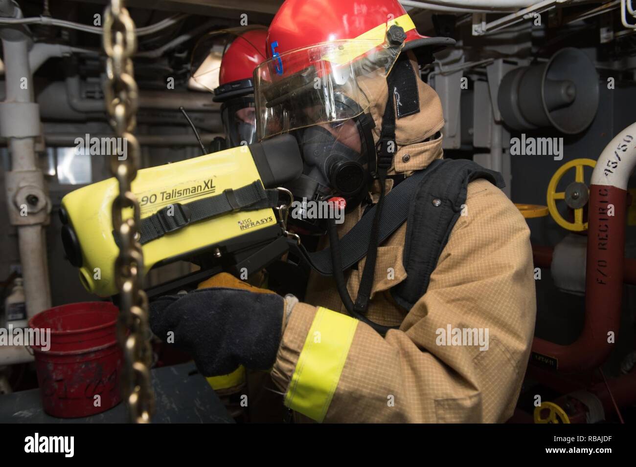 Damage Controlman Fireman Joshua Roman, from Ciales, Puerto Rico, uses ...