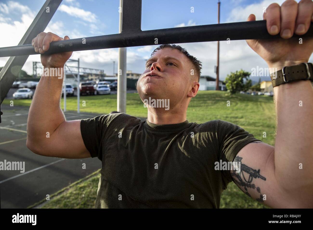 A U.S. Marine conducts pull-ups during a Headquarters Battalion ...