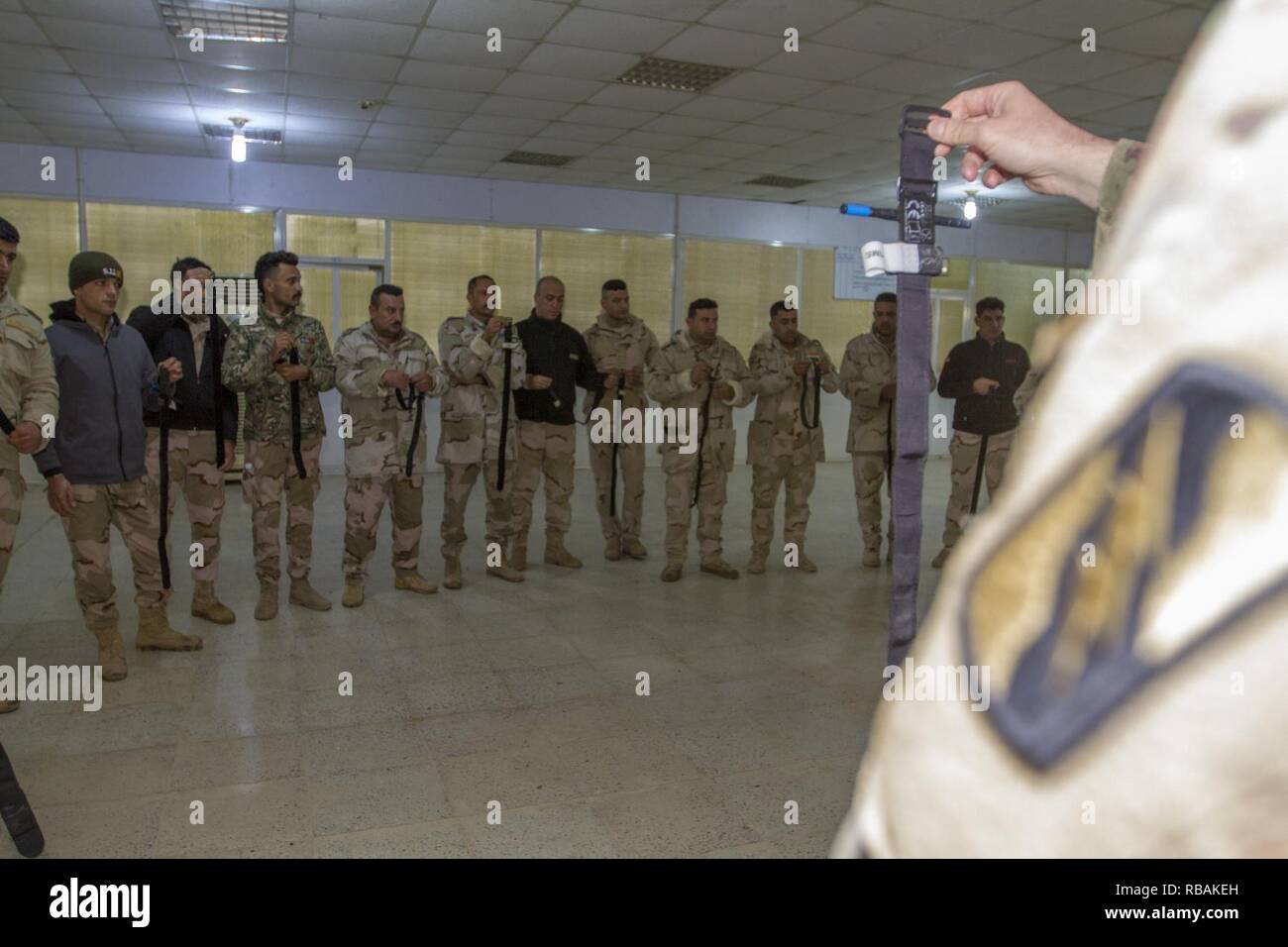 Iraqi soldiers prepare to conduct self-aid using a tourniquet during a ...