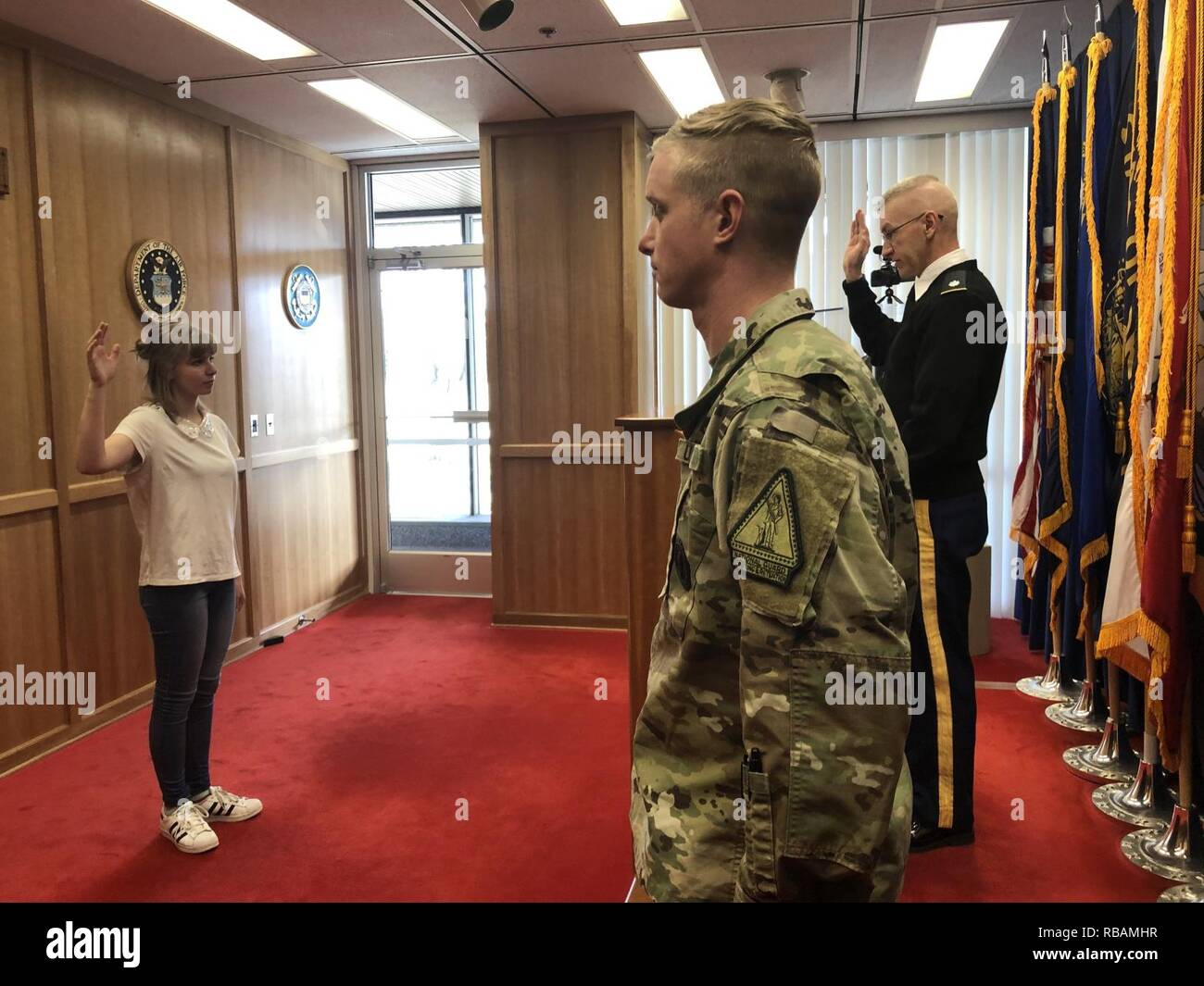 Lt. Col. David Darney administers the oath of enlistment to his ...