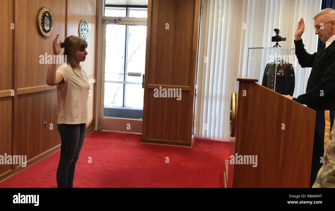 Lt. Col. David Darney administers the oath of enlistment to his ...