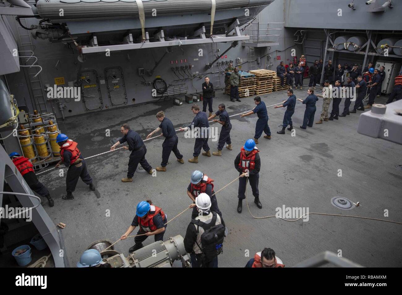 Sailors with Beachmaster Unit (BMU) 2 and Assault Craft Unit (ACU) 4, lend a hand during a ...