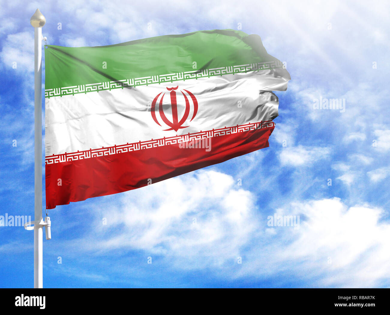 National flag of Iran on a flagpole in front of blue sky Stock Photo ...
