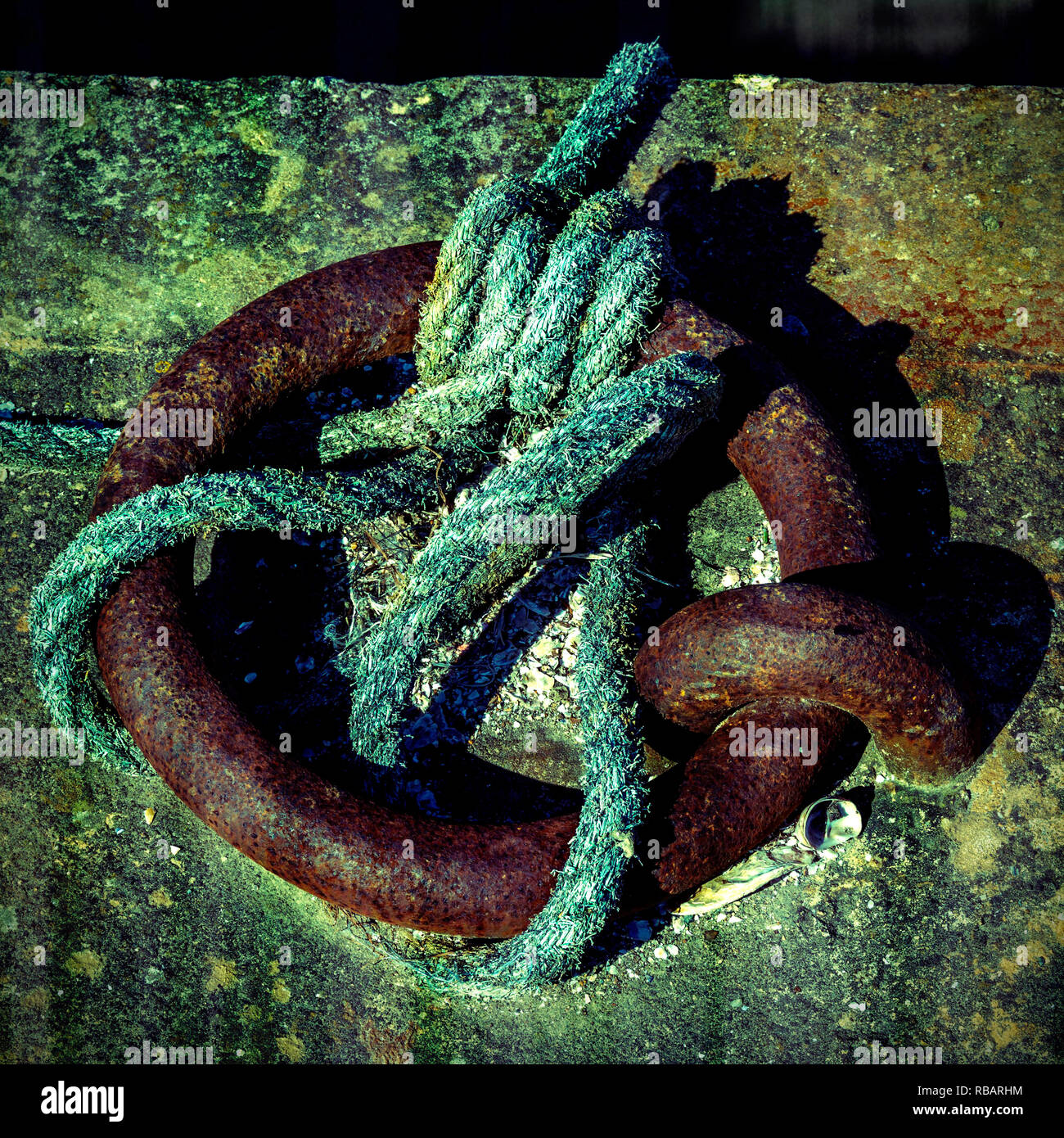 Rope tied around a rusty metal ring hi-res stock photography and images ...