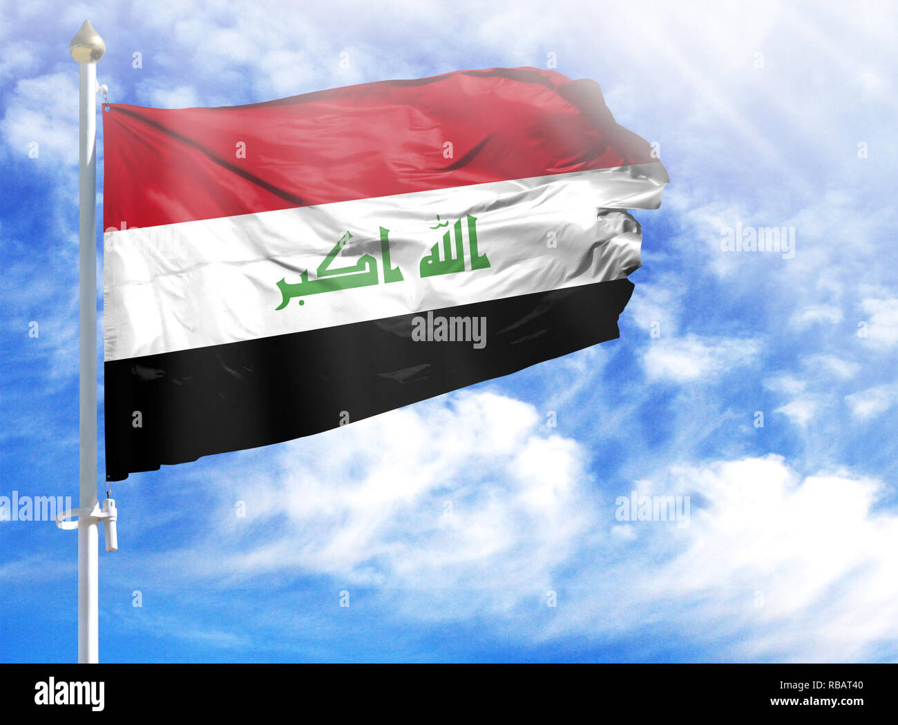 National flag of Iraq on a flagpole in front of blue sky Stock Photo ...