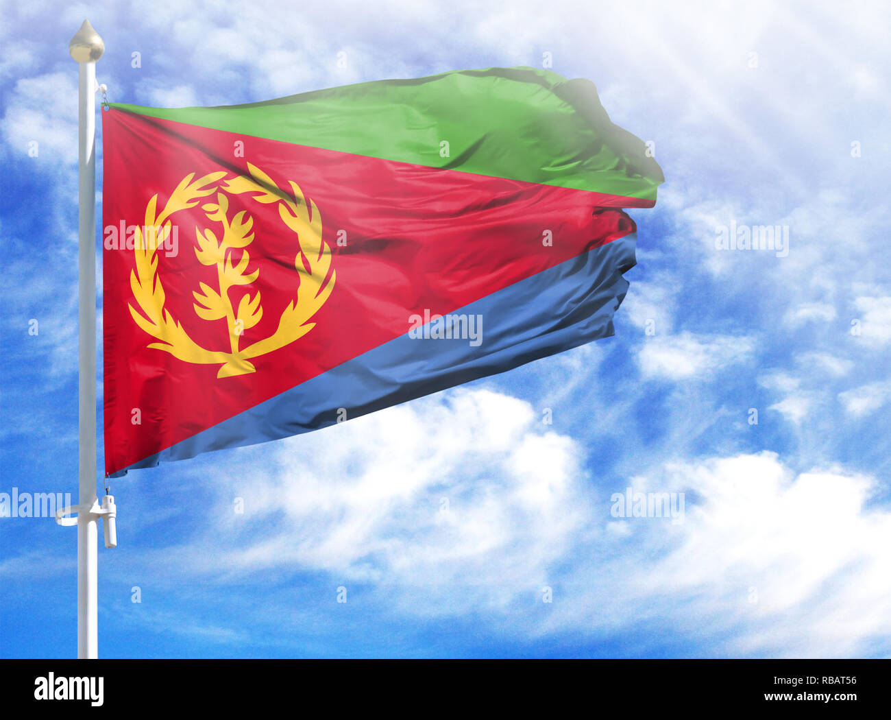 National flag of Eritrea on a flagpole in front of blue sky Stock Photo ...