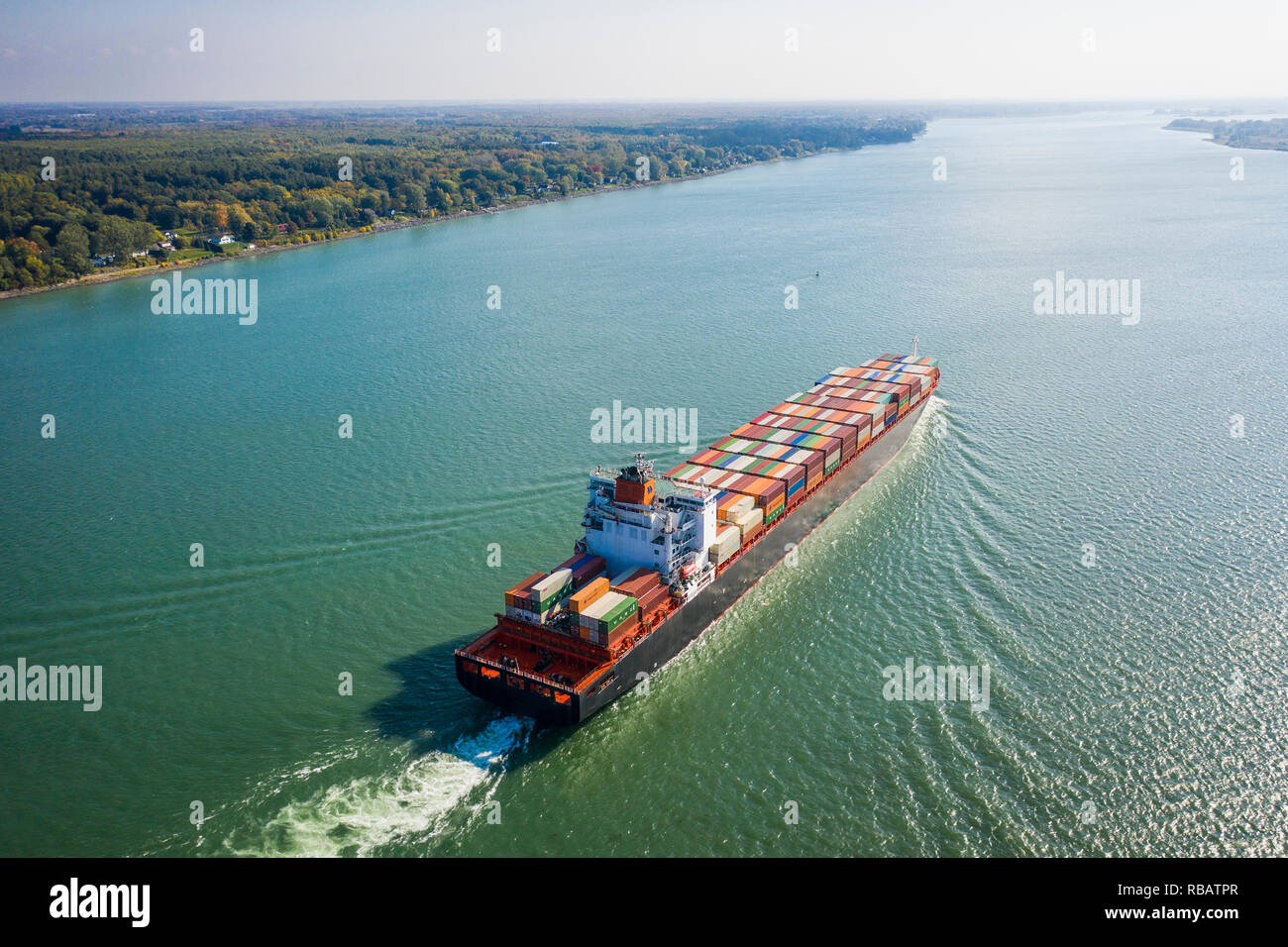 Aerial view of a container ship going upstream in the St. Lawrence ...