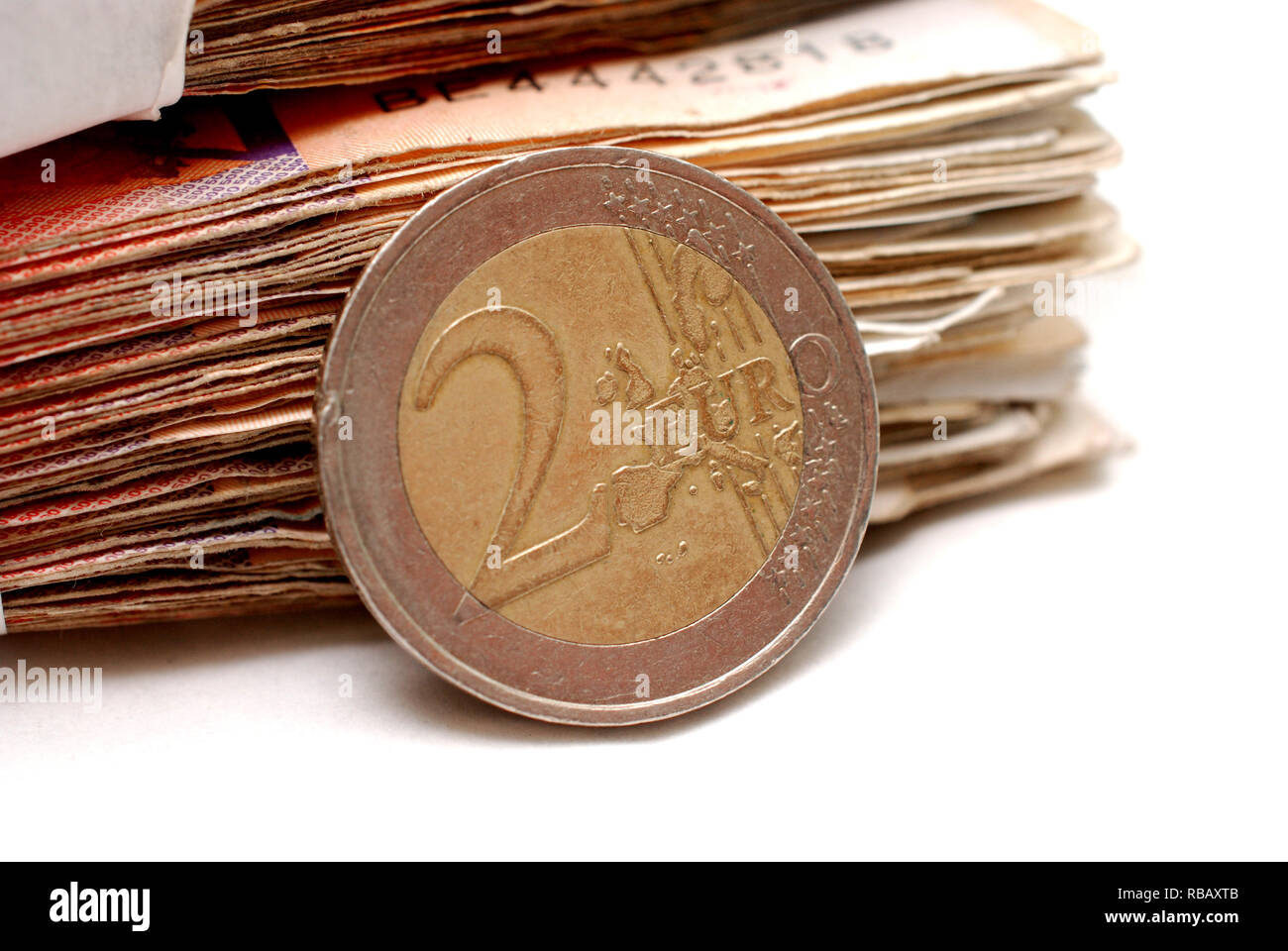 two euro coin on a banknote background, image of a Stock Photo - Alamy