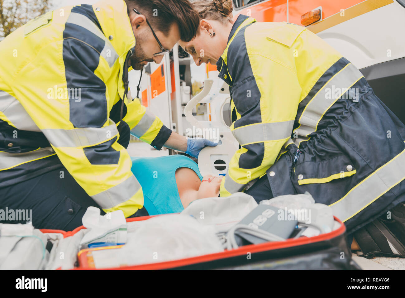 Paramedics performing first aid at ambulance Stock Photo - Alamy