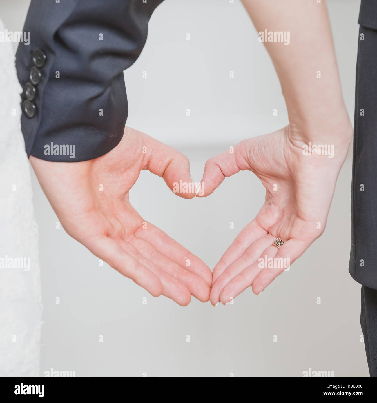 wedding couple showing shape of heart from their hands Stock Photo - Alamy