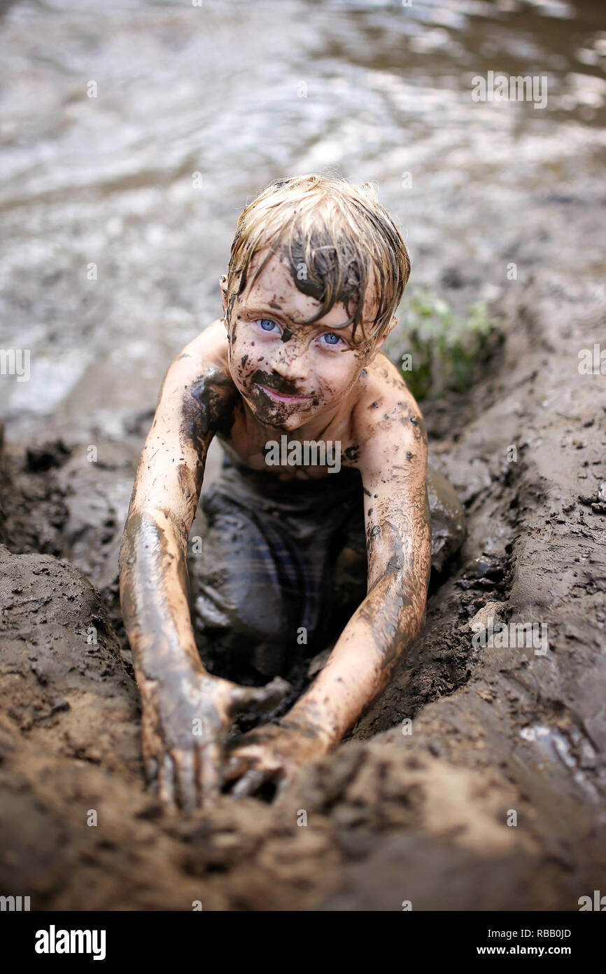 Happy boy in mud hi-res stock photography and images - Alamy