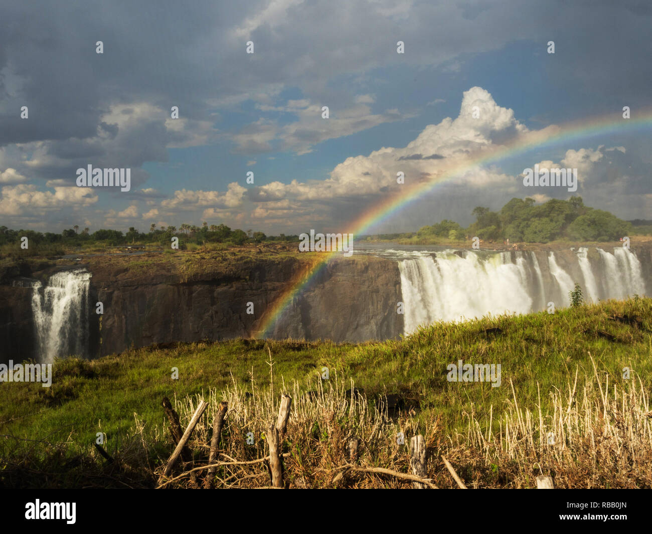 Rainbow over Victoria Falls on Zambezi River. Victoria falls is a ...