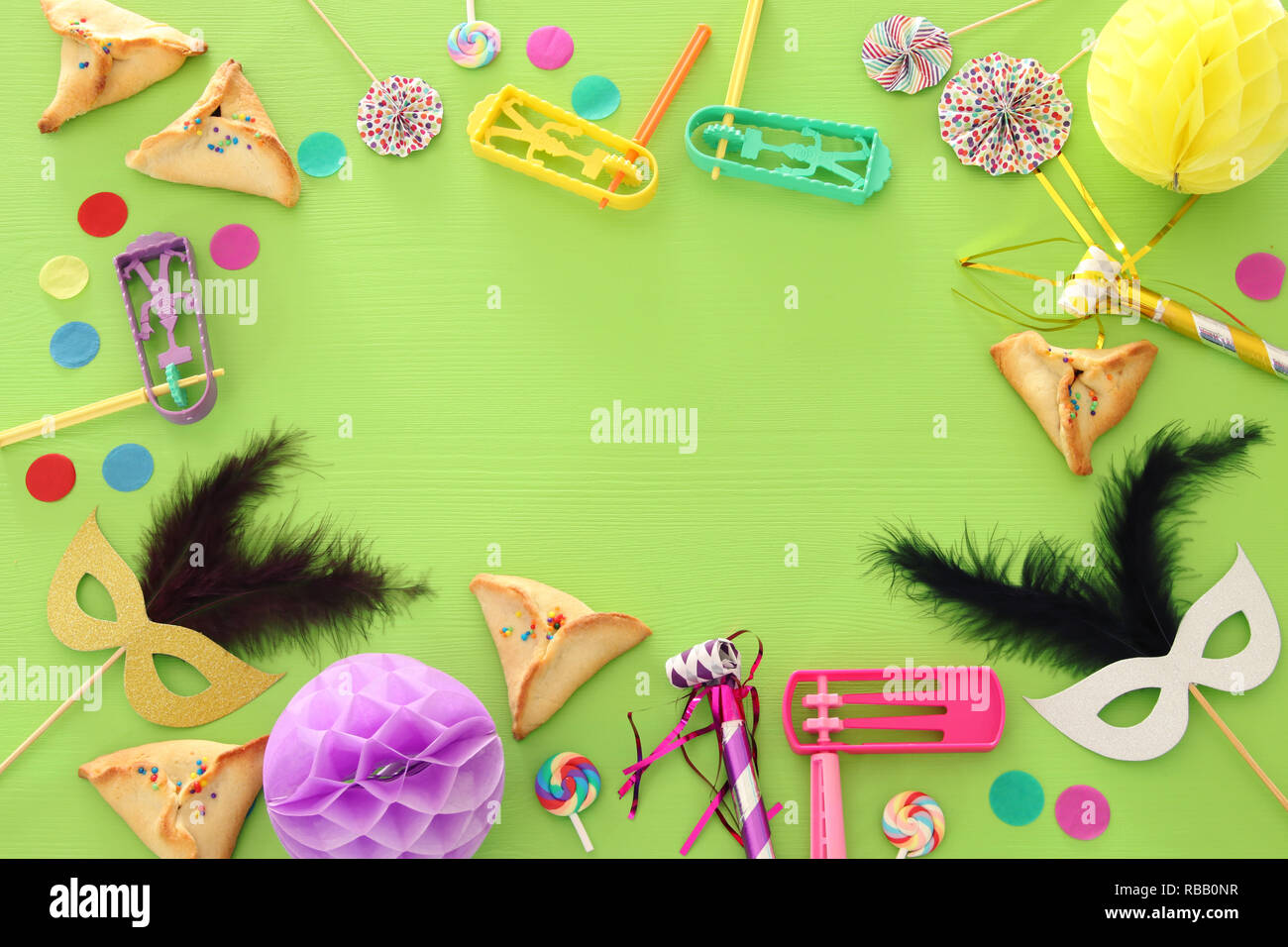 Purim celebration concept (jewish carnival holiday) over wooden green ...