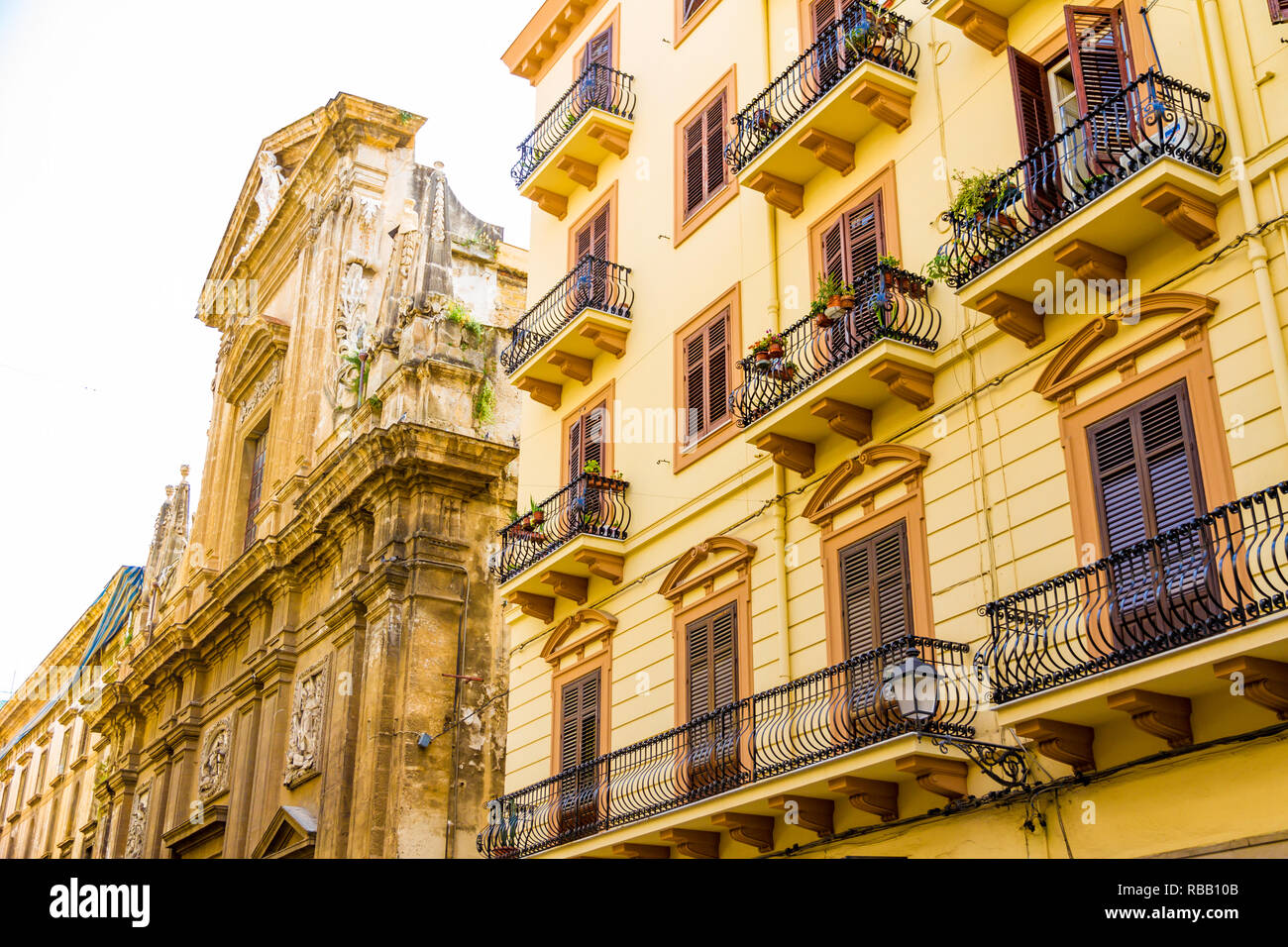 Church and building with balconies in old town center of Palermo, Italy ...